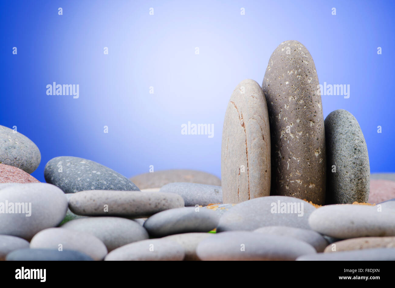 Balanced pebbles with colour background Stock Photo - Alamy