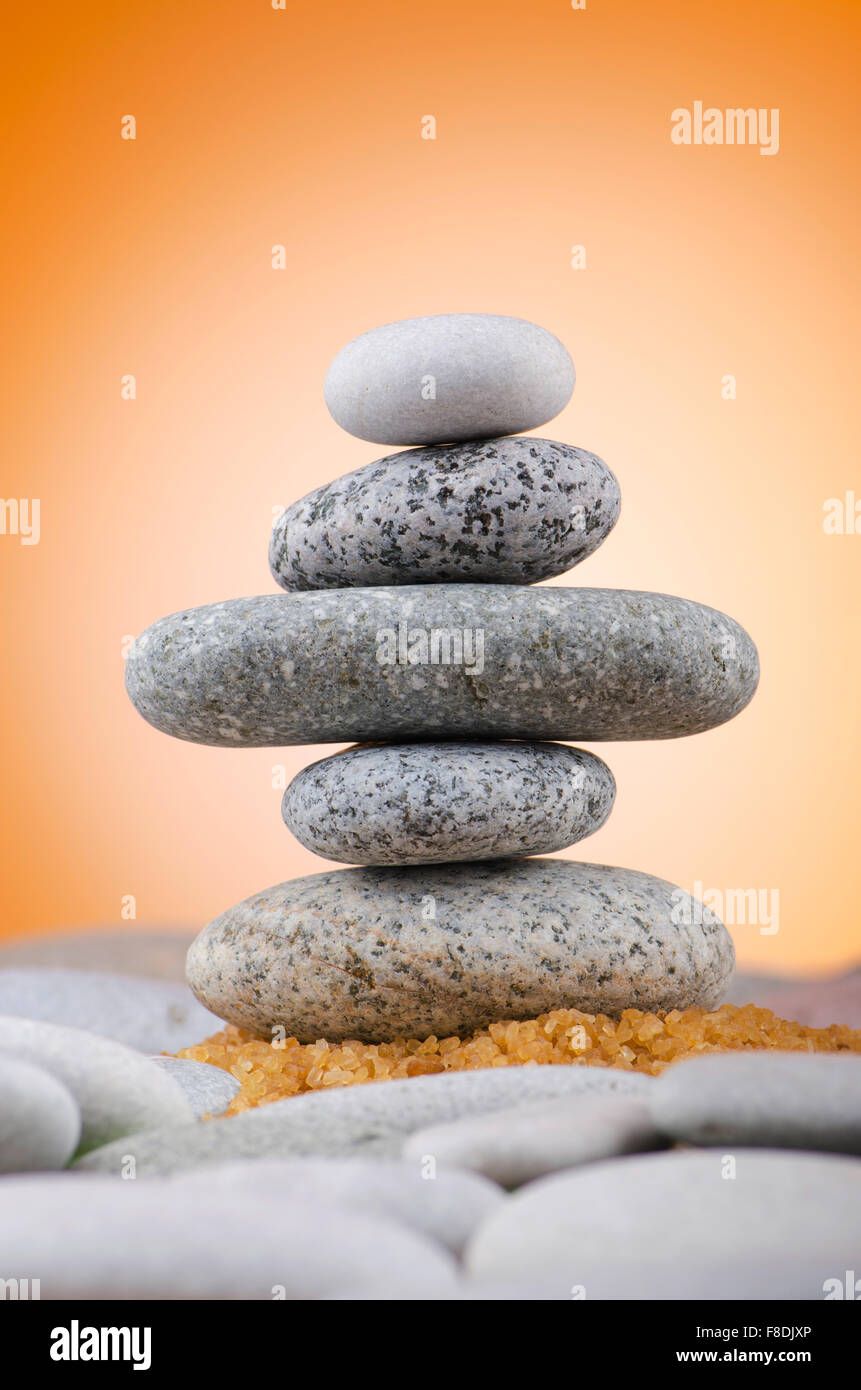 Balanced pebbles with colour background Stock Photo - Alamy