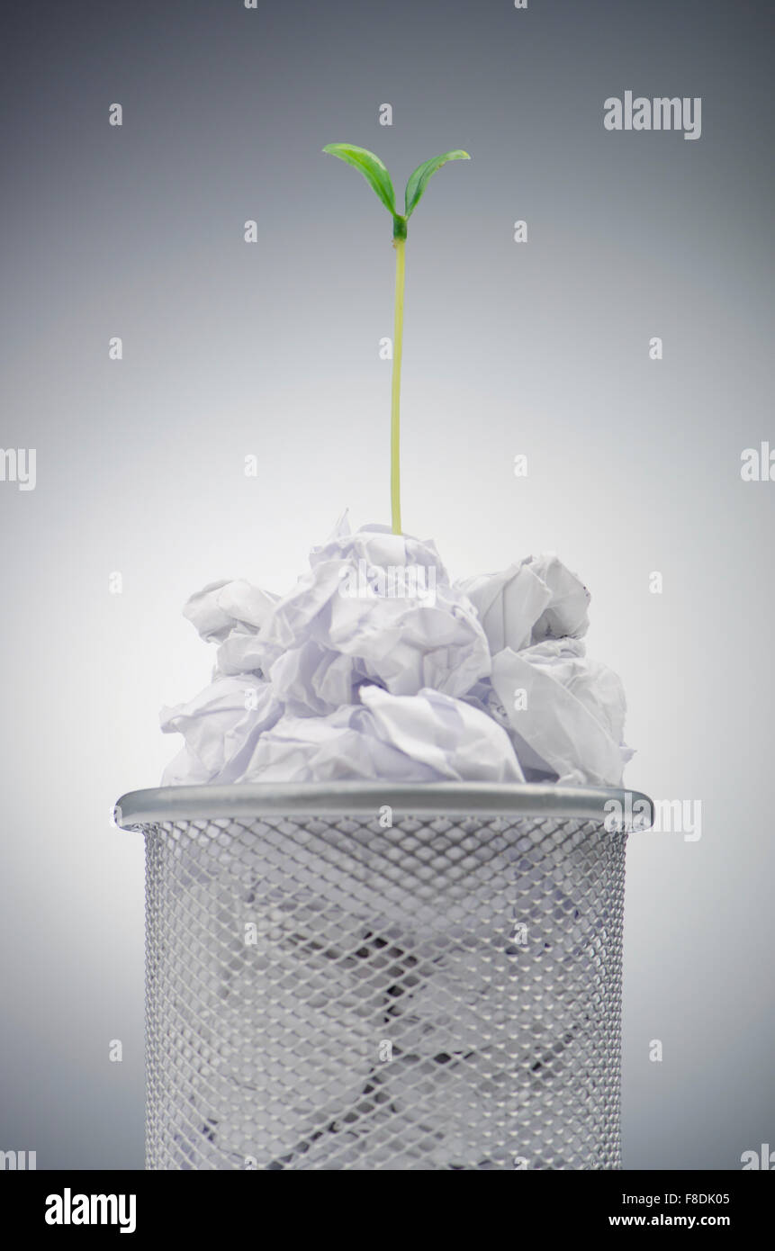 Green seedlings growing out of paper Stock Photo - Alamy