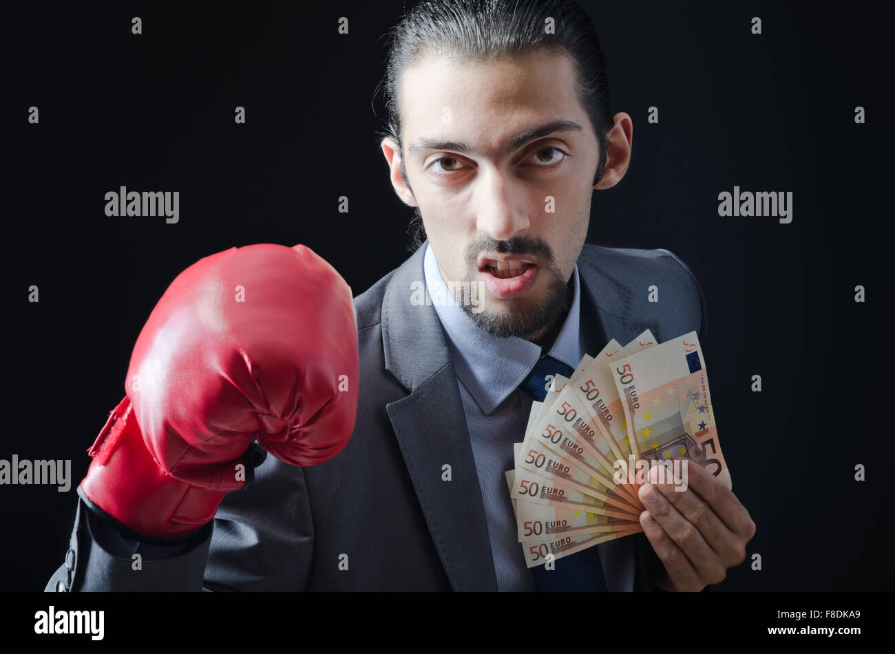 Man with boxing gloves and money Stock Photo - Alamy