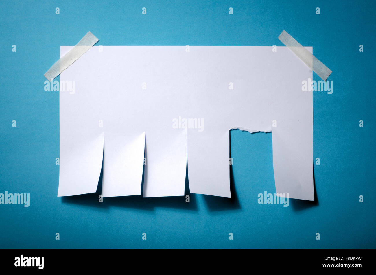Tear off paper notice on the wall Stock Photo - Alamy
