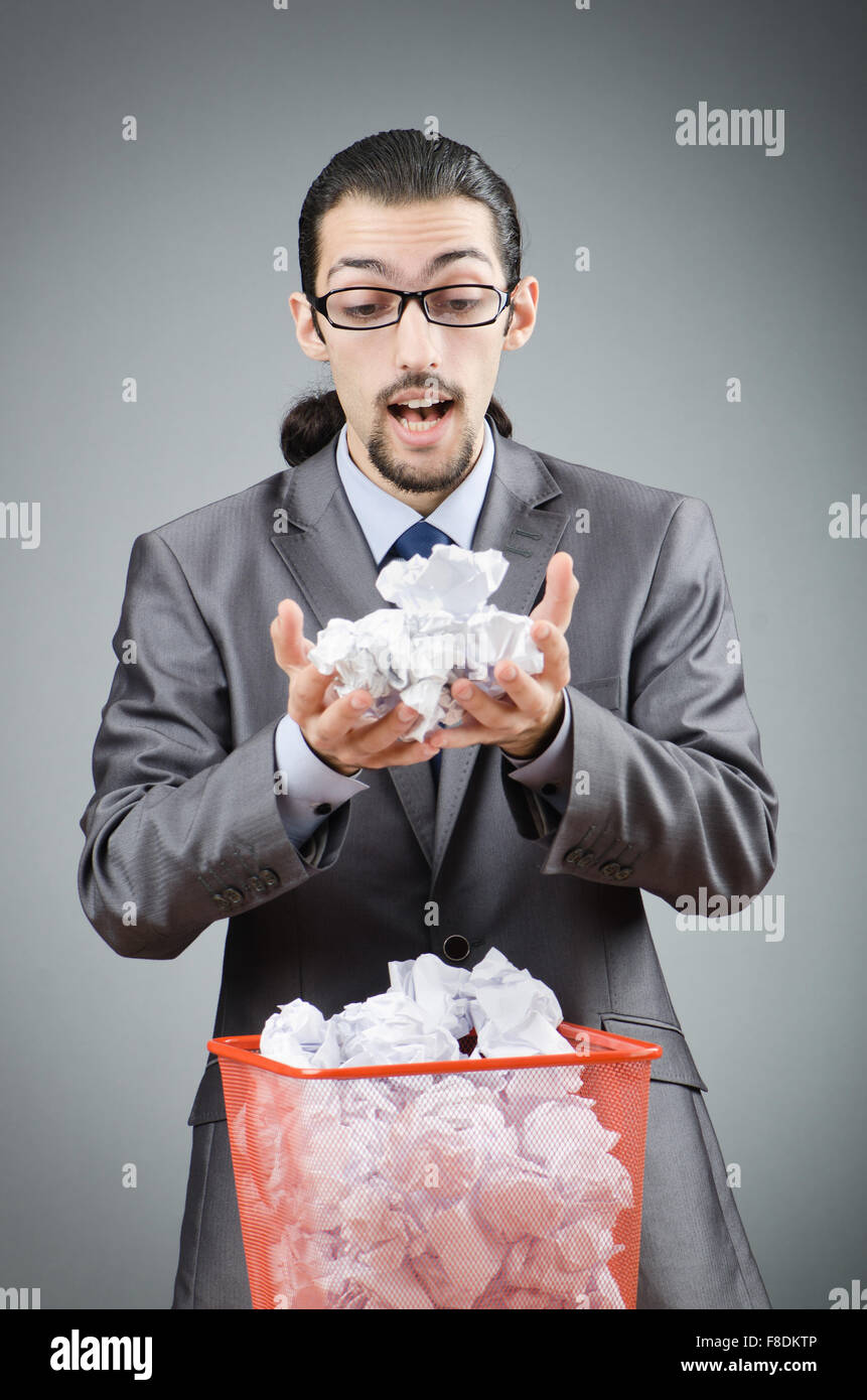 Man with lots of wasted paper Stock Photo - Alamy