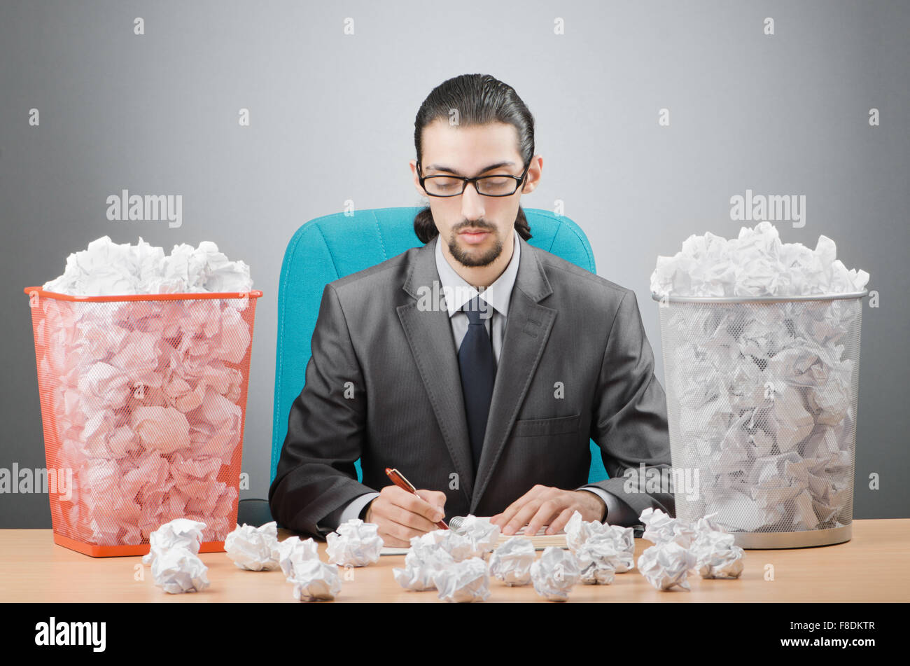 Man with lots of wasted paper Stock Photo - Alamy