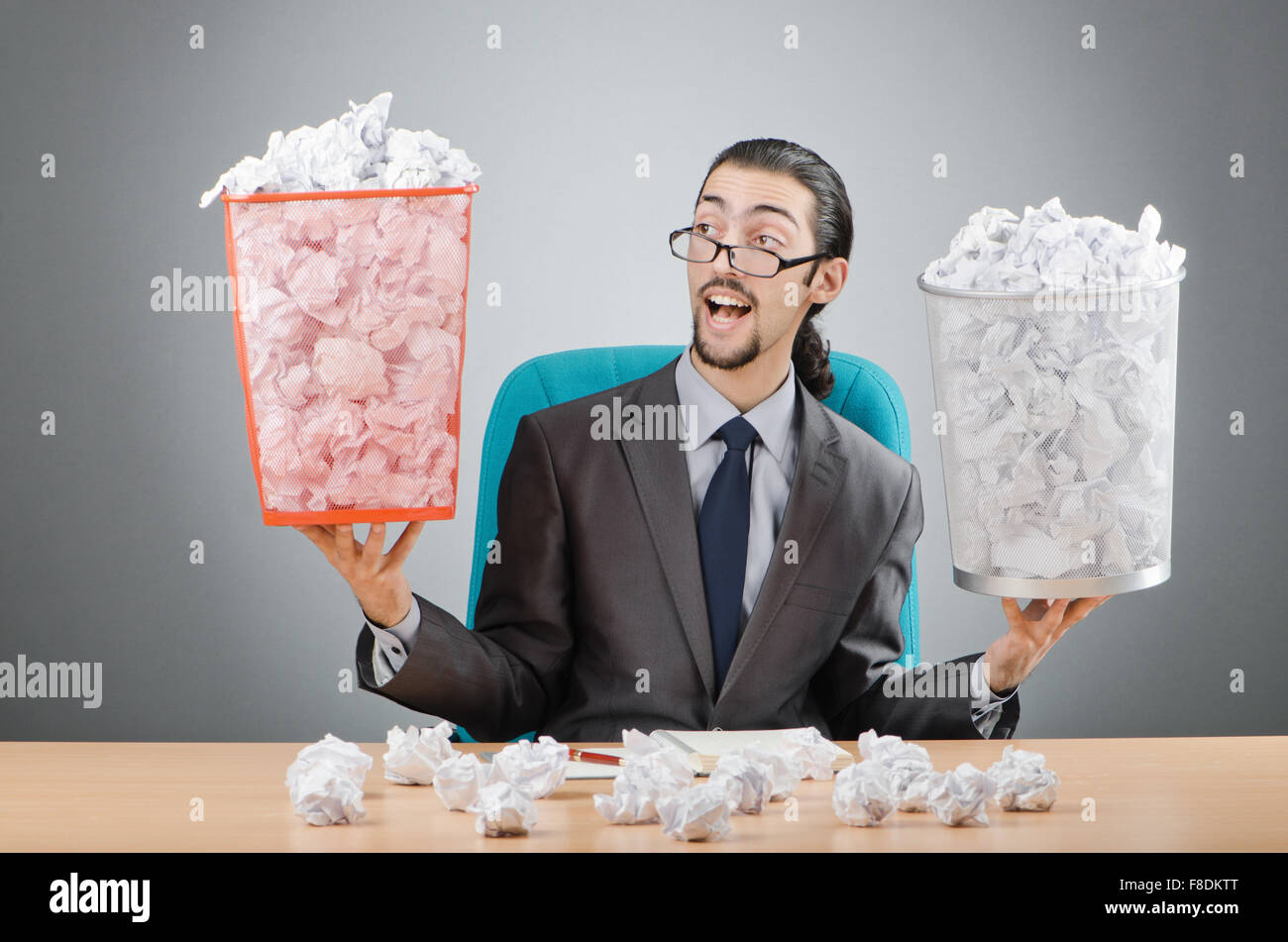 Man with lots of wasted paper Stock Photo - Alamy