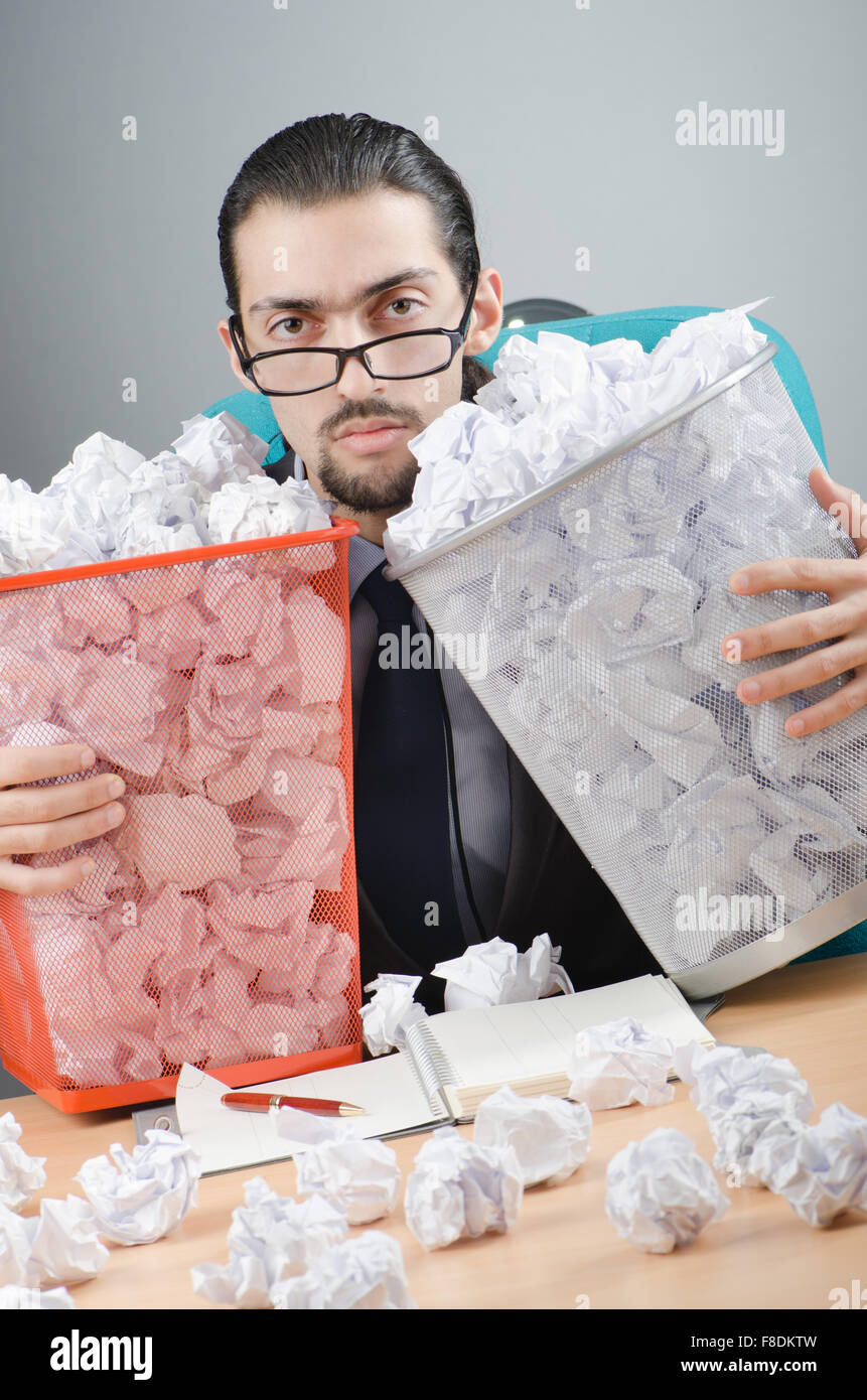 Man with lots of wasted paper Stock Photo - Alamy