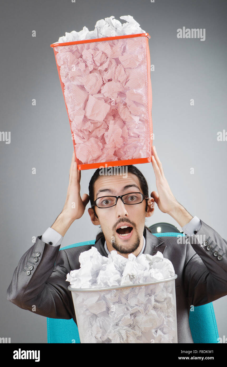 Man with lots of wasted paper Stock Photo - Alamy