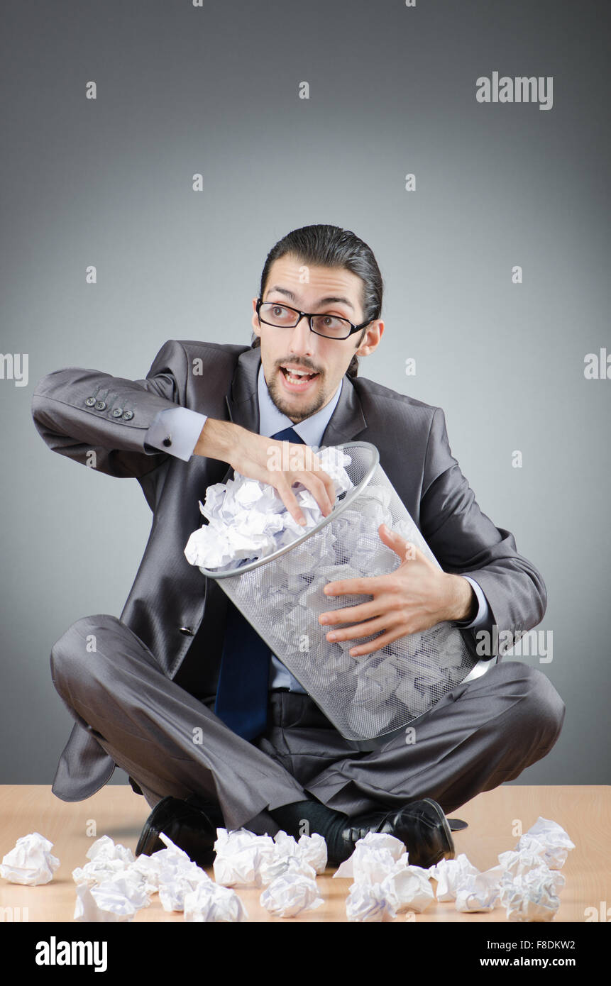 Man with lots of wasted paper Stock Photo - Alamy