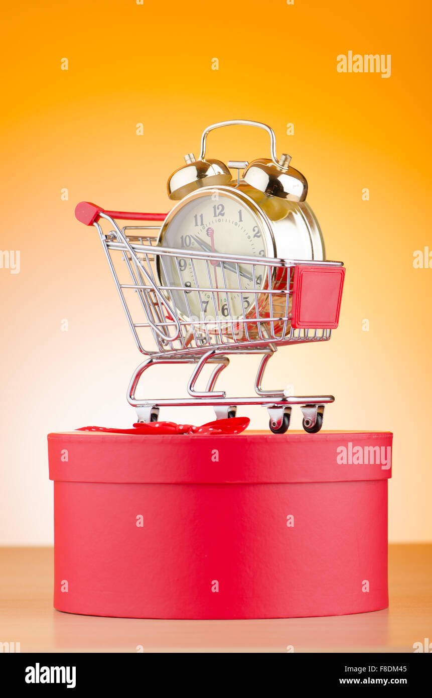 Buying time concept with clock and shopping cart Stock Photo - Alamy