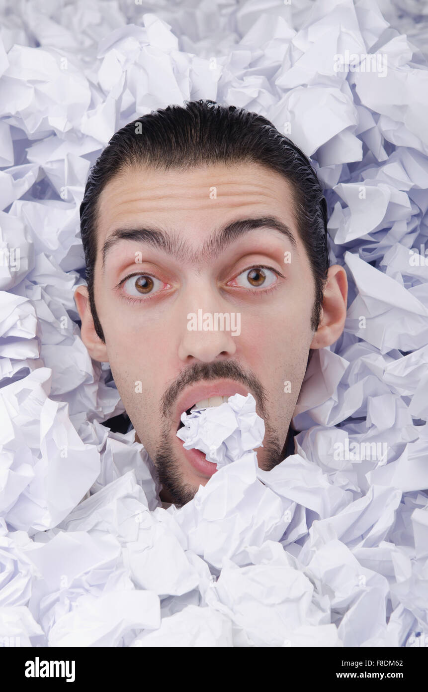 Man with lots of crumpled paper Stock Photo - Alamy