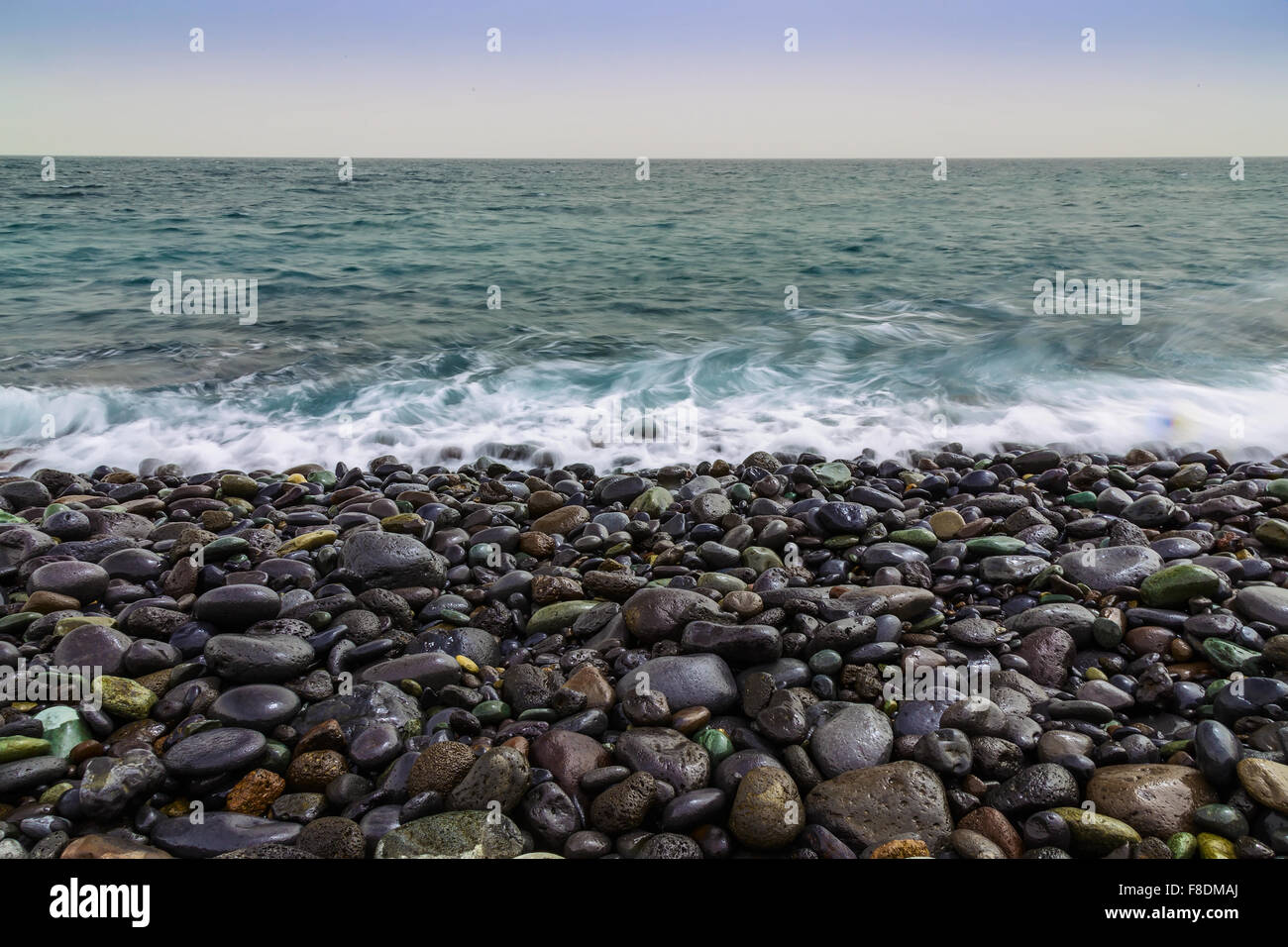 Stone Coast or Shore of Ocean with Silky Waves and Foam from long ...