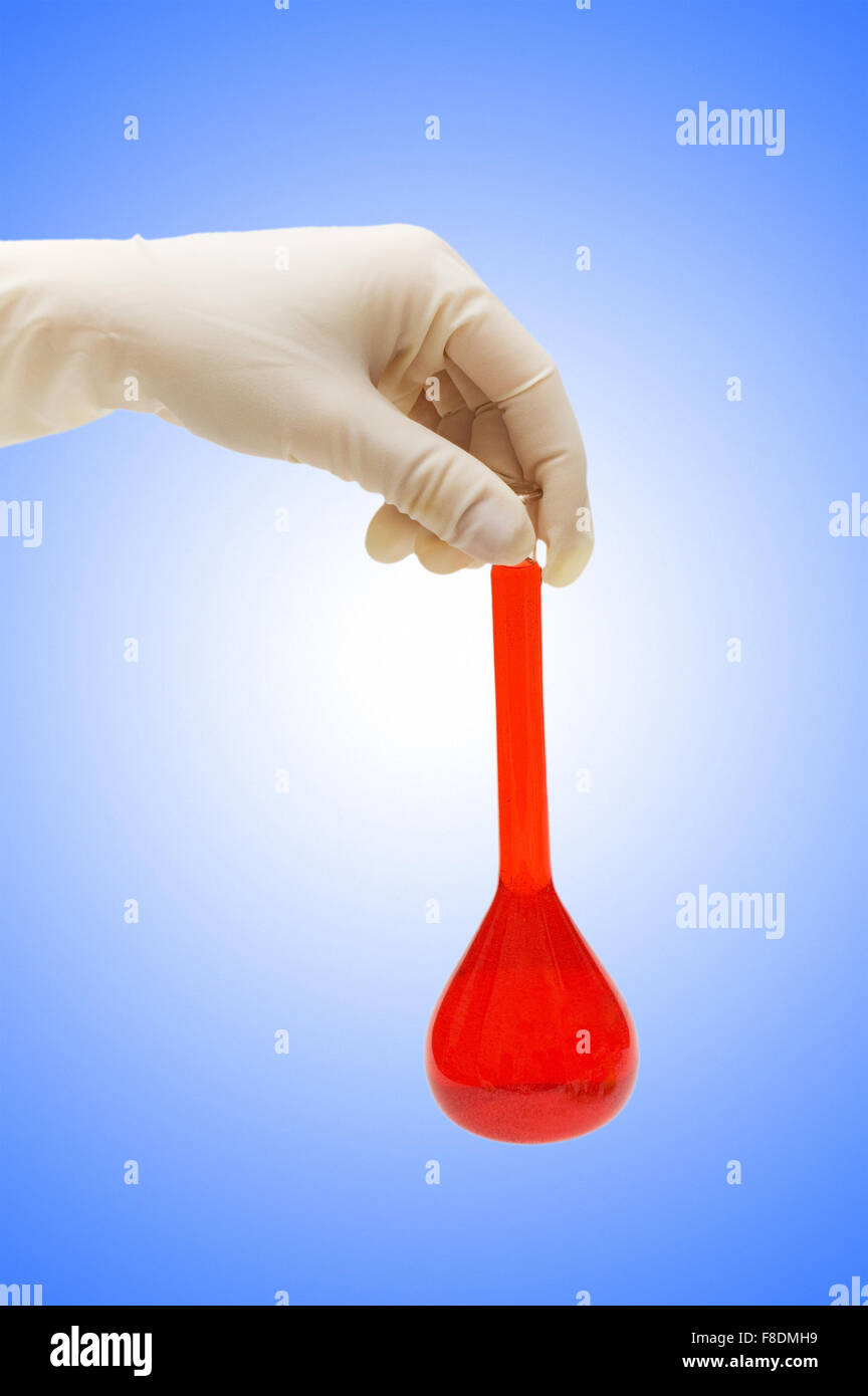 Hand with chemical solutions on gradient Stock Photo - Alamy