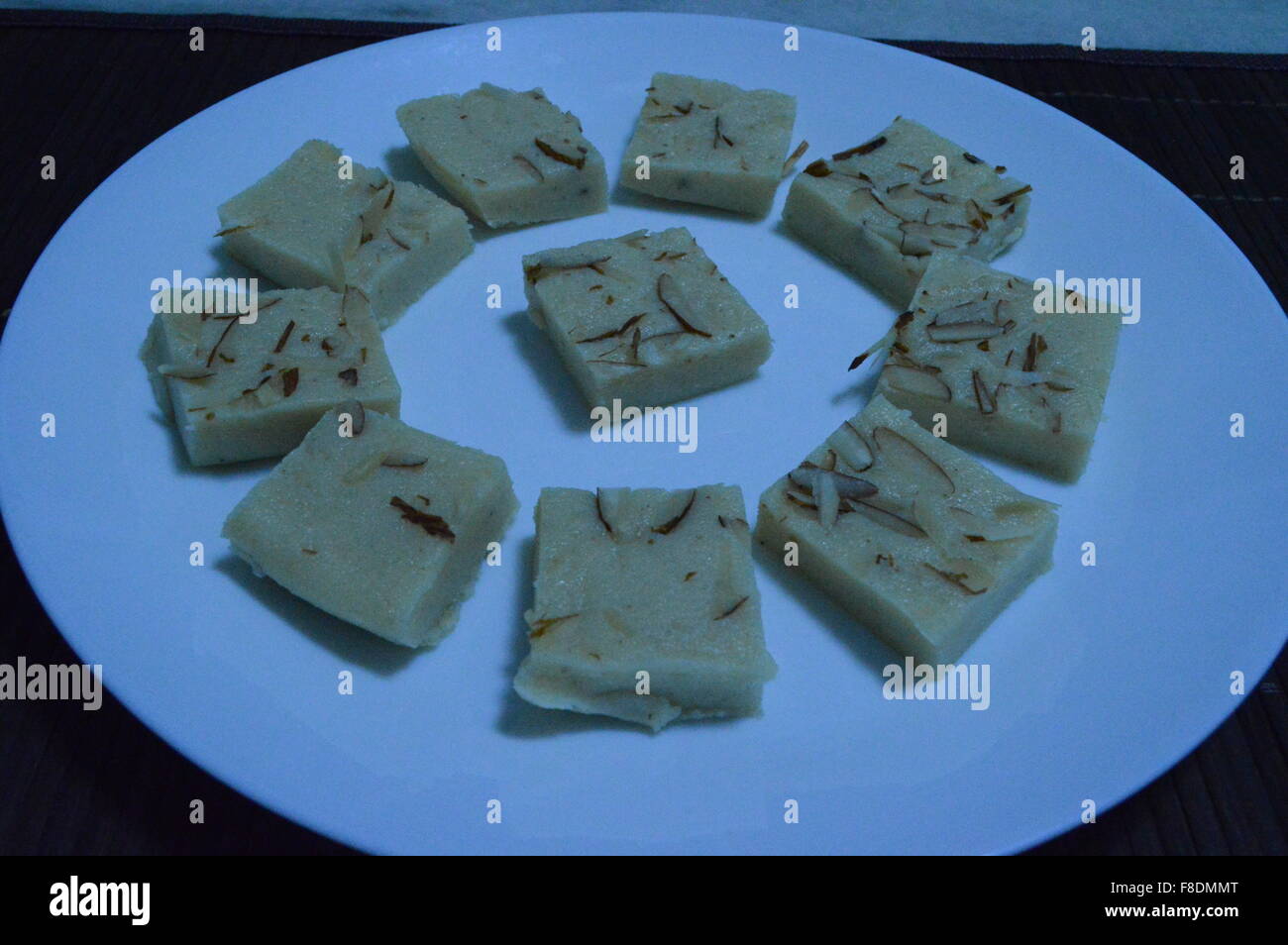 Indian sweet disc made from milk, sugar and nuts Stock Photo - Alamy