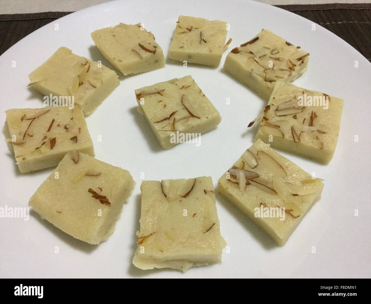 Indian sweet disc made from milk, sugar and nuts Stock Photo - Alamy