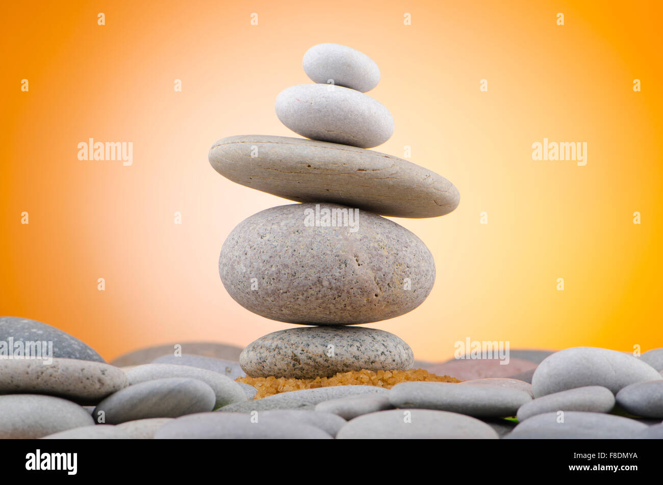 Balanced pebbles with colour background Stock Photo - Alamy