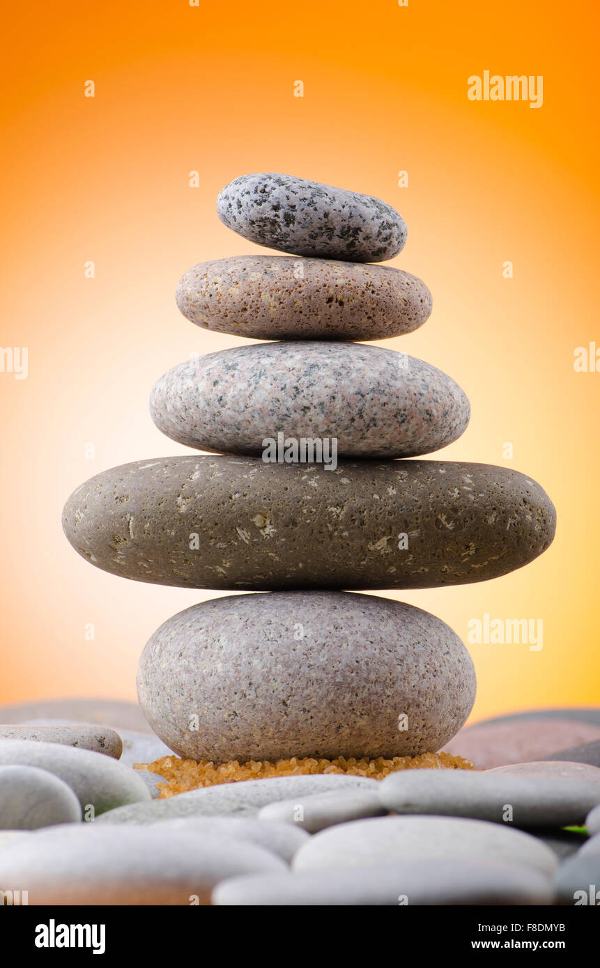 Balanced pebbles with colour background Stock Photo - Alamy