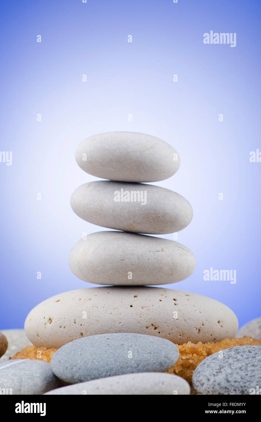 Balanced pebbles with colour background Stock Photo - Alamy