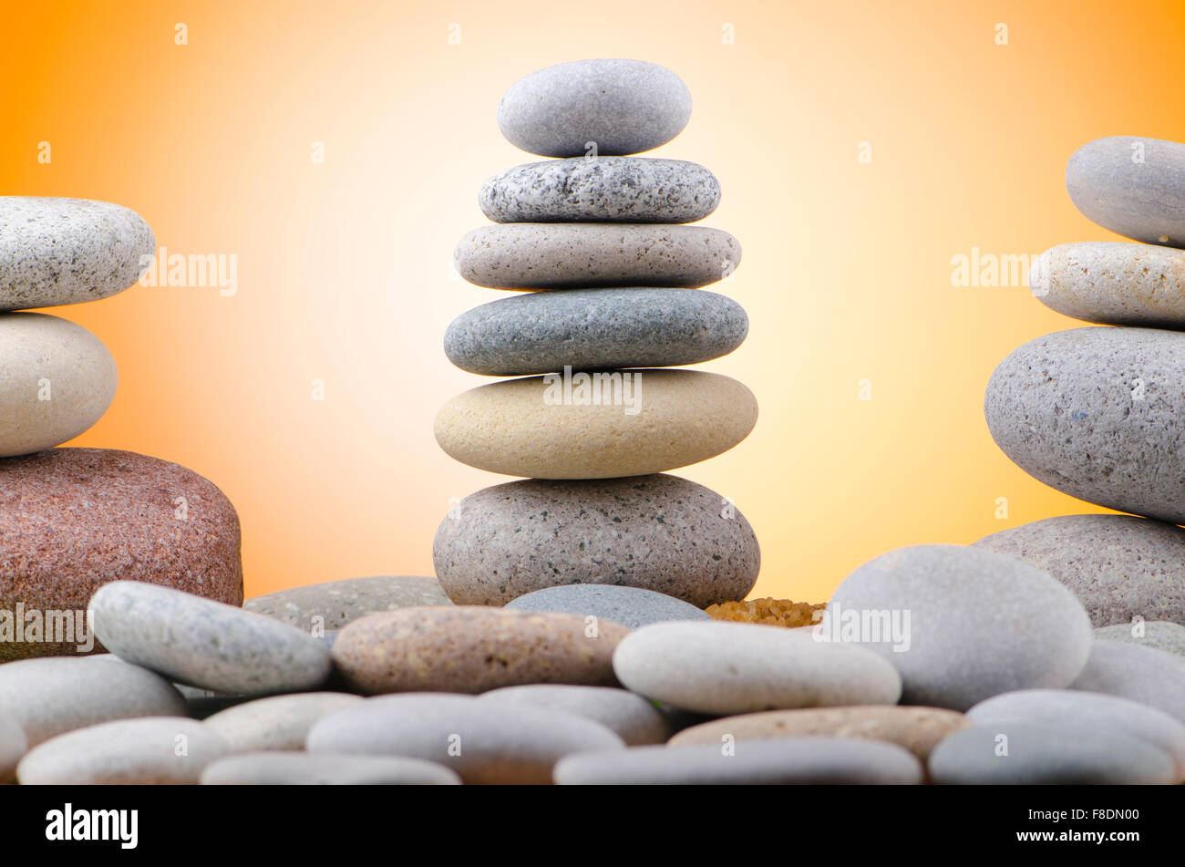 Balanced pebbles with colour background Stock Photo - Alamy