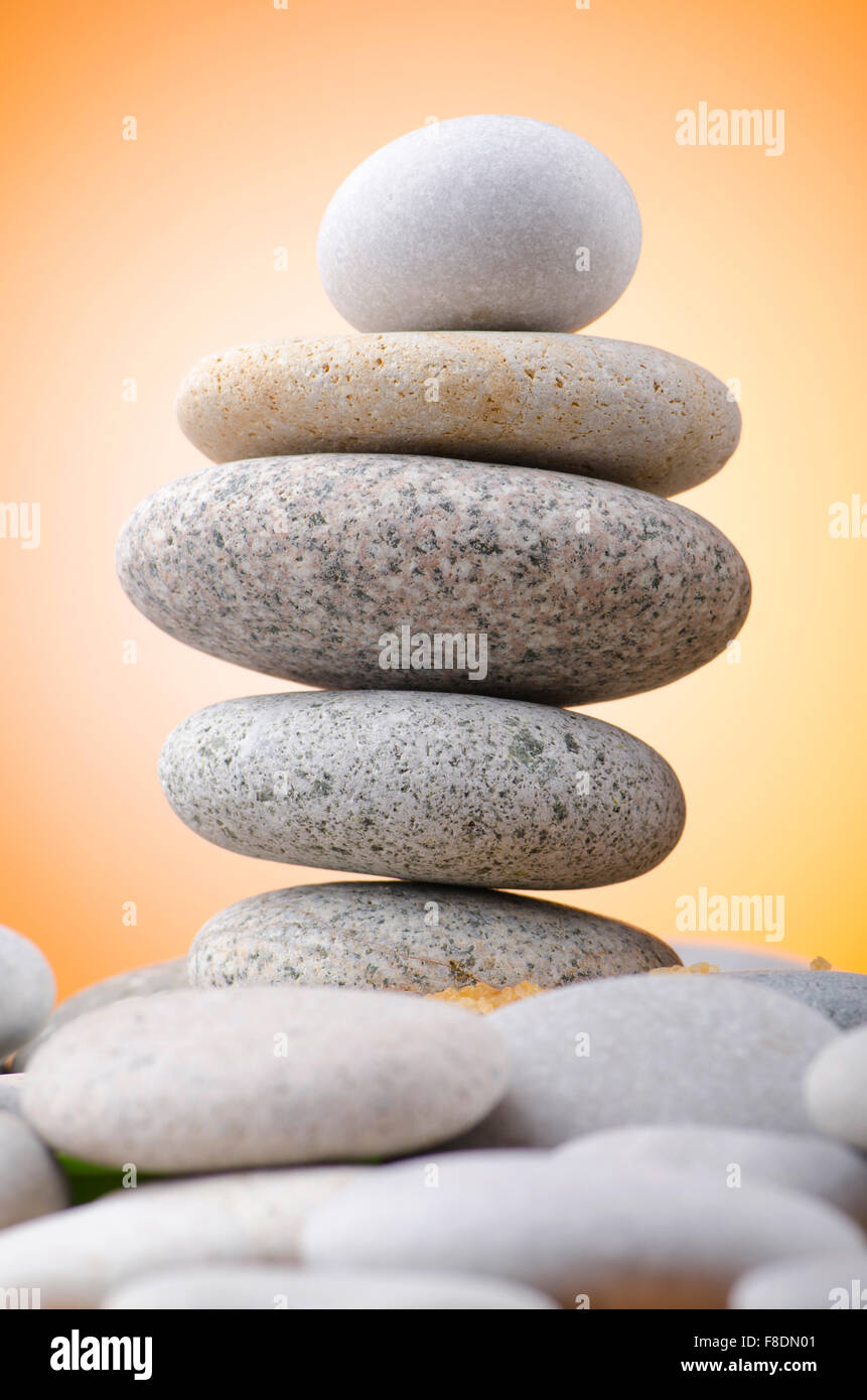 Balanced pebbles with colour background Stock Photo - Alamy