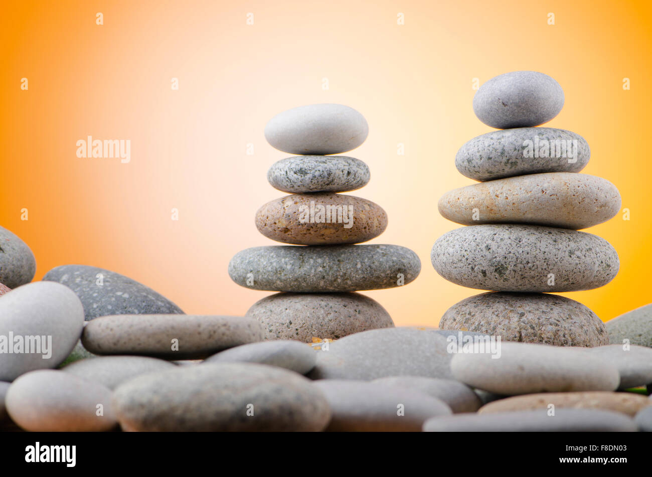 Balanced pebbles with colour background Stock Photo - Alamy