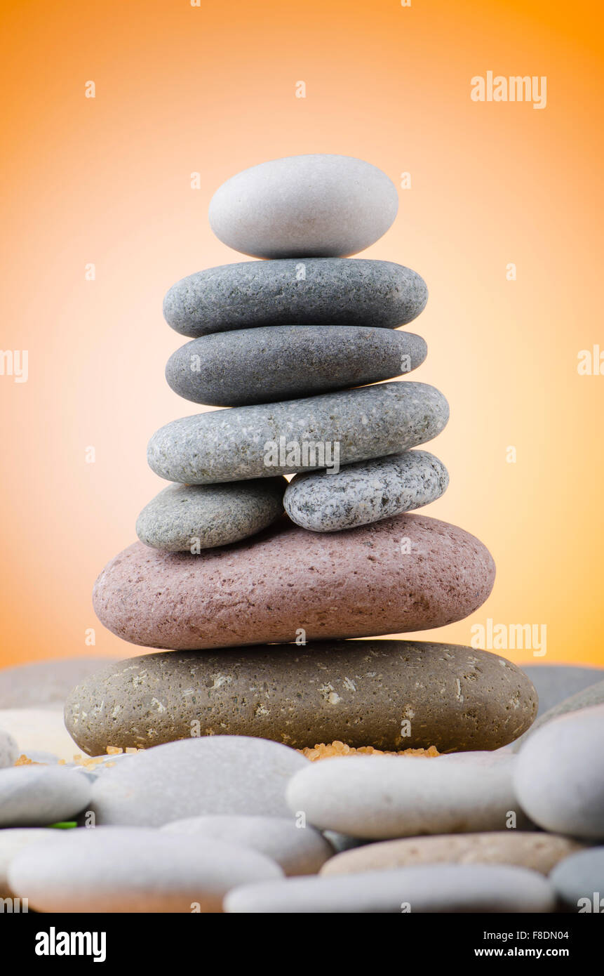 Balanced pebbles with colour background Stock Photo - Alamy