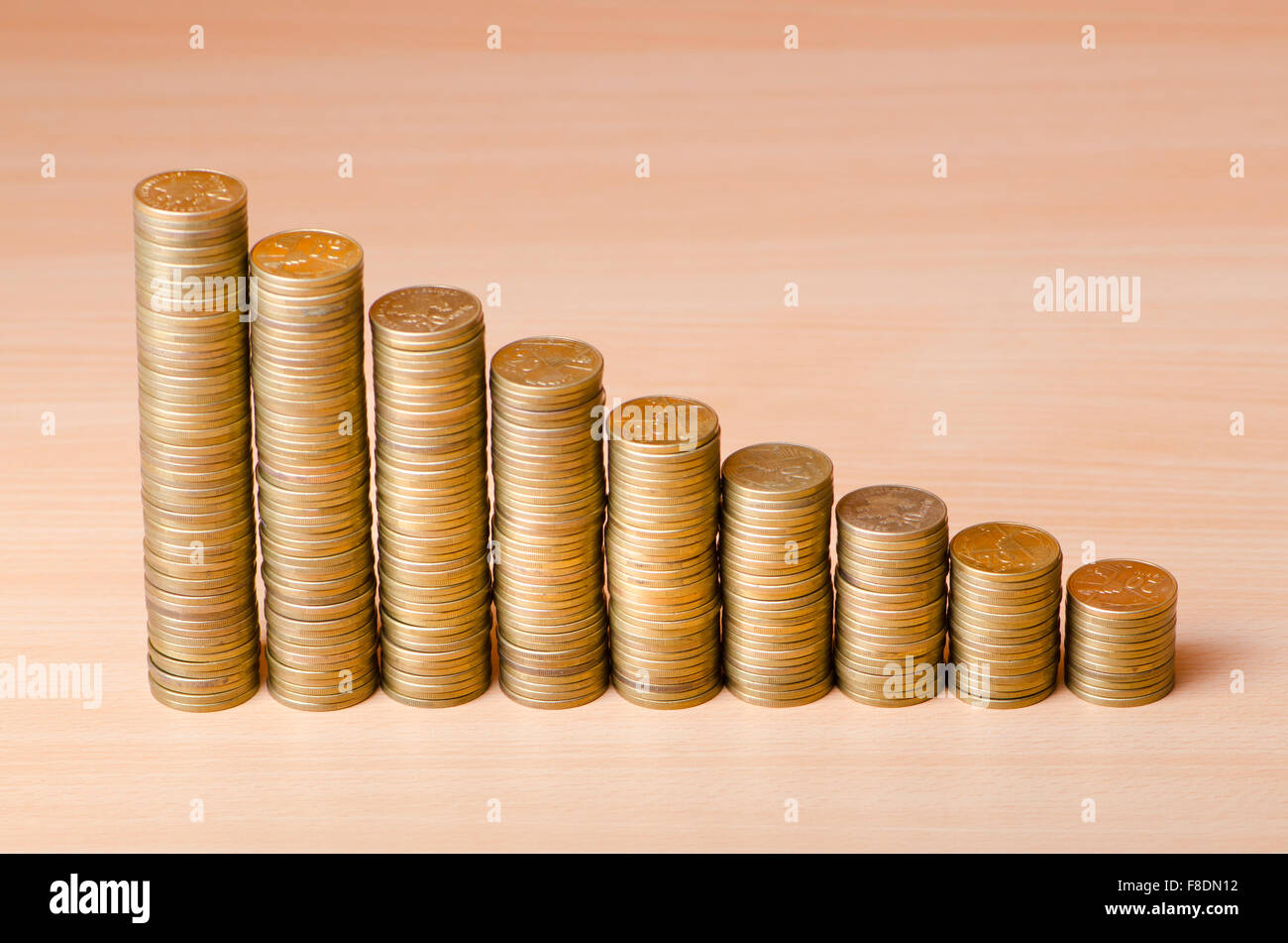 Golden coins in high stacks Stock Photo - Alamy
