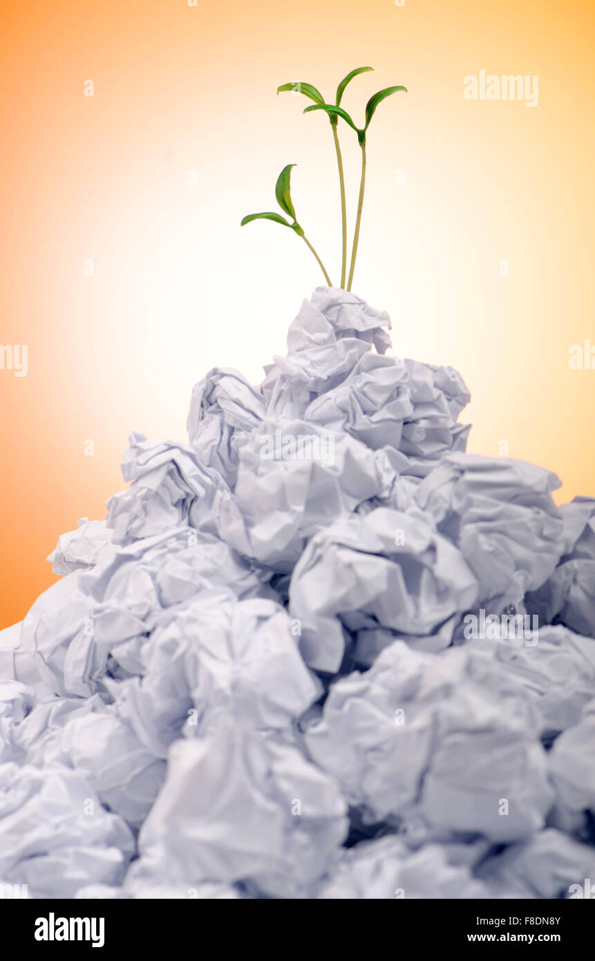 Green seedlings growing out of paper Stock Photo - Alamy