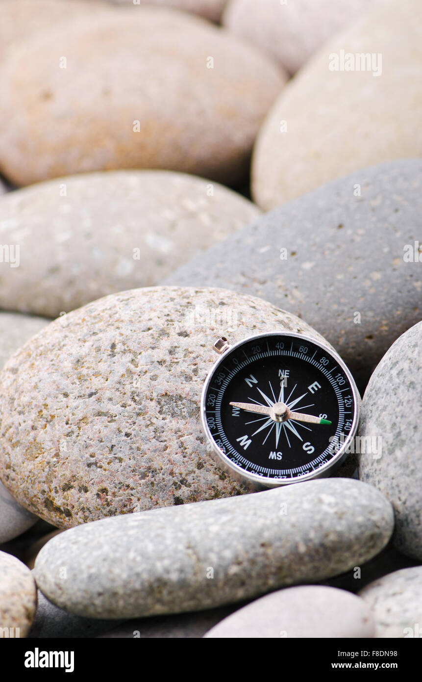 Navigation compass on stone pebbles Stock Photo - Alamy
