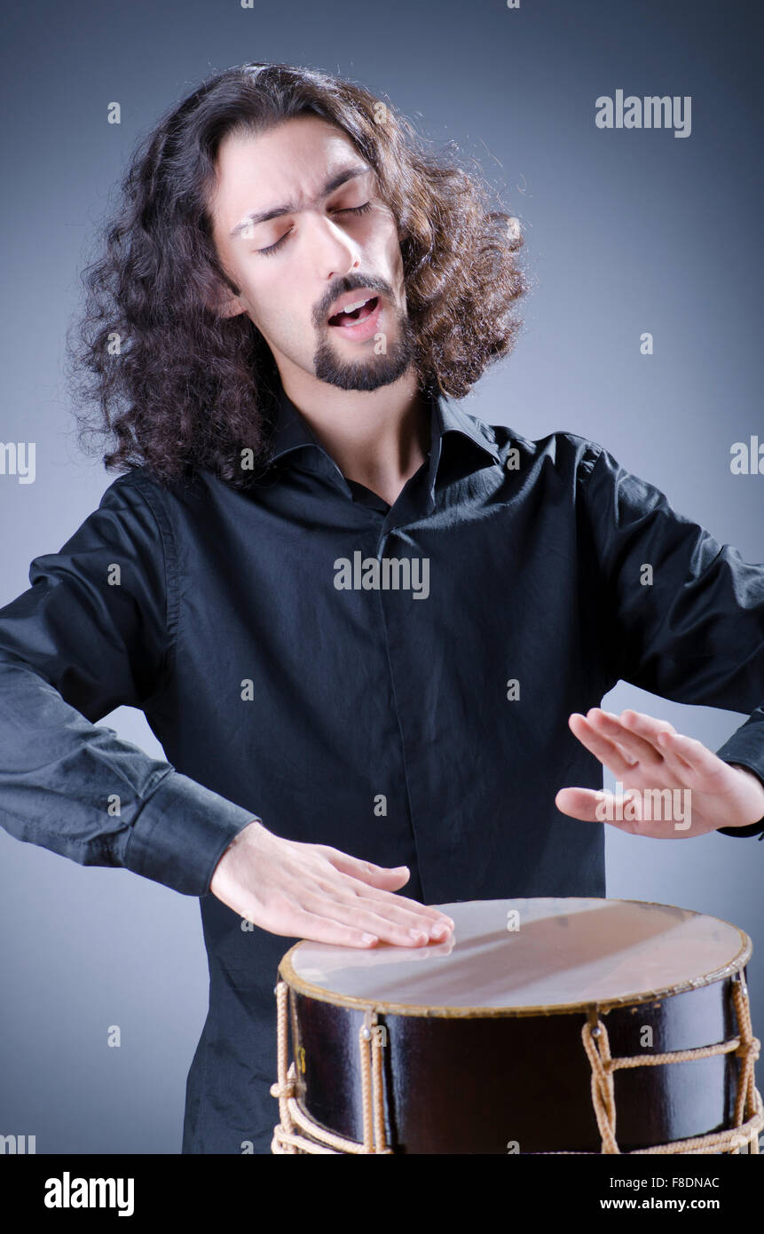 Man playing drum in studio Stock Photo - Alamy