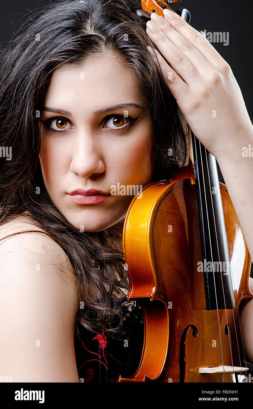 Female violin player against background Stock Photo - Alamy