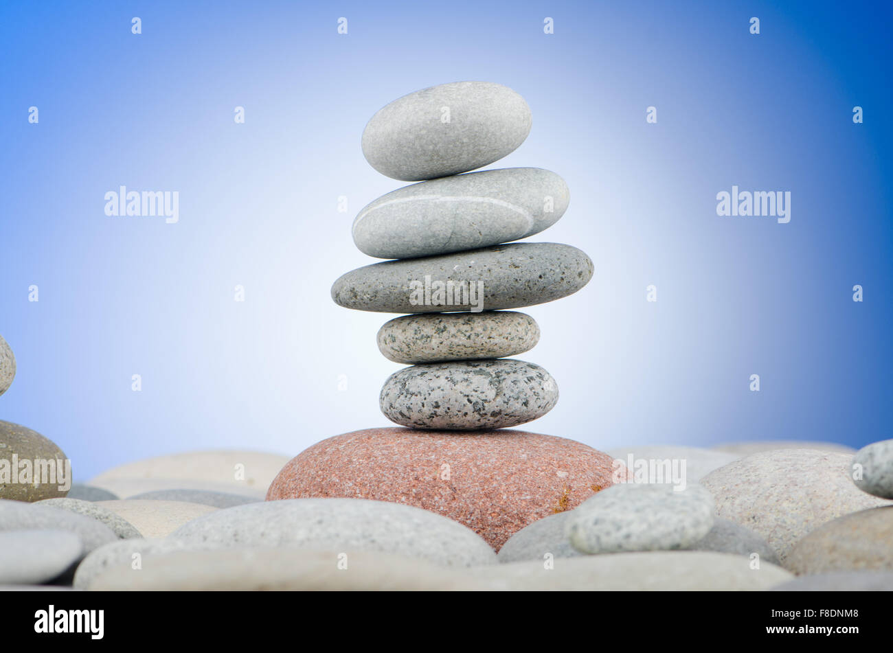 Pebbles stack against gradient background Stock Photo - Alamy