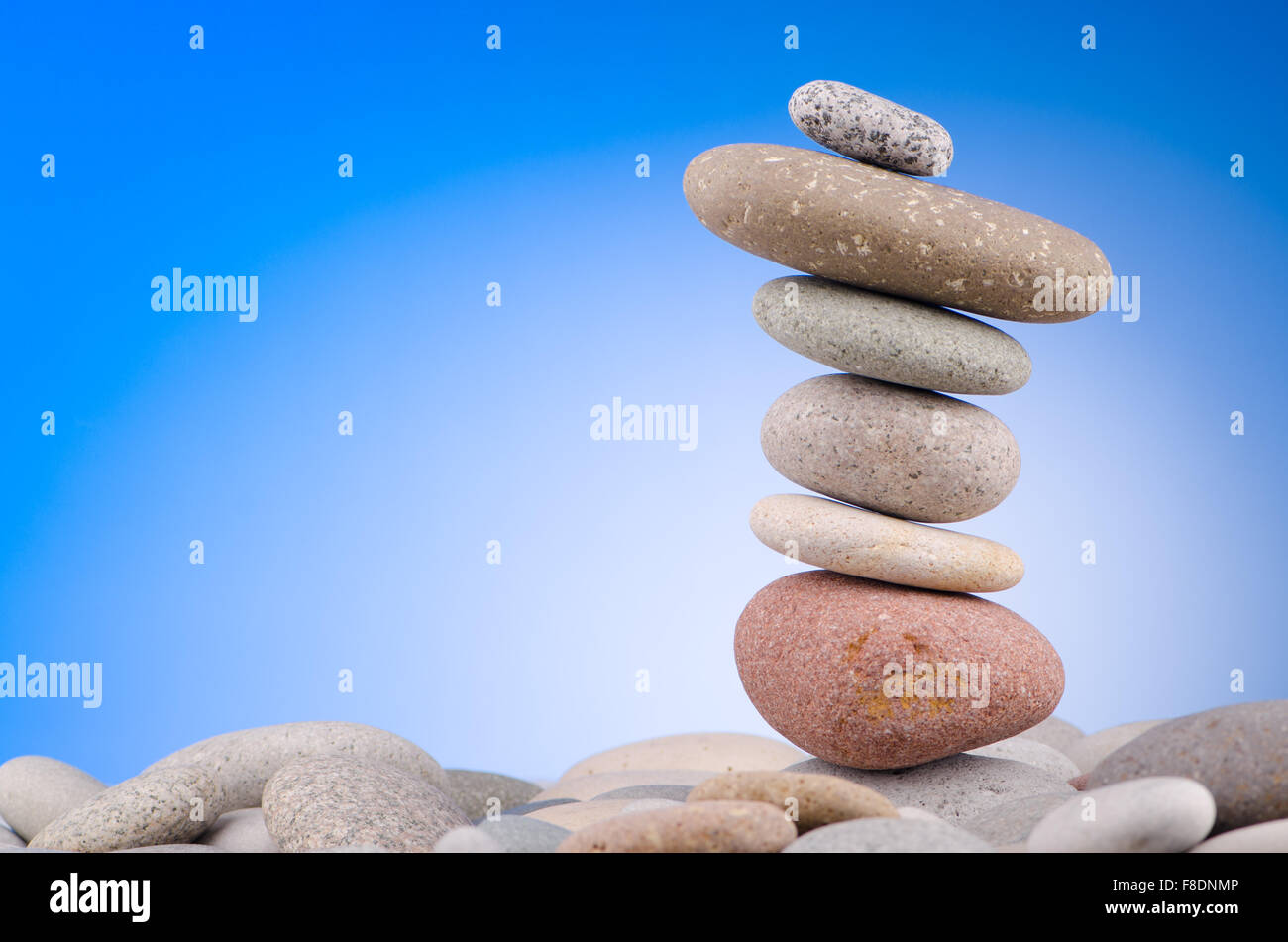 Pebbles stack against gradient background Stock Photo - Alamy