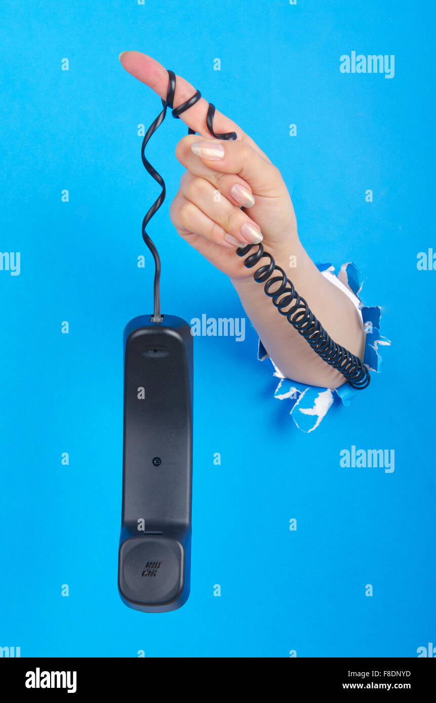 Hand with phone out of paper hole Stock Photo - Alamy