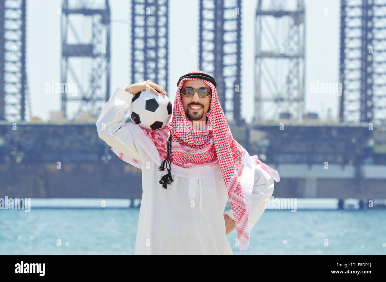 Arab with footbal at seaside Stock Photo - Alamy