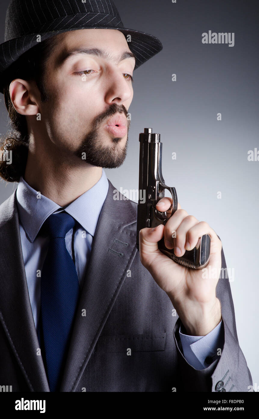 Businessman man with hand gun Stock Photo - Alamy