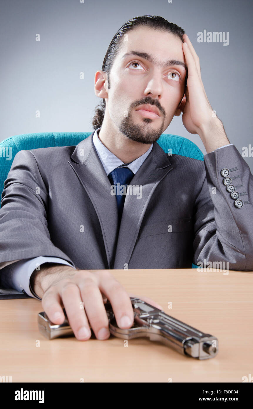 Businessman man with hand gun Stock Photo - Alamy