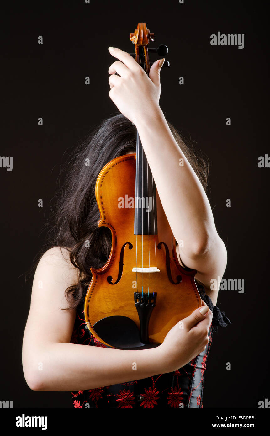 Female violin player against background Stock Photo - Alamy