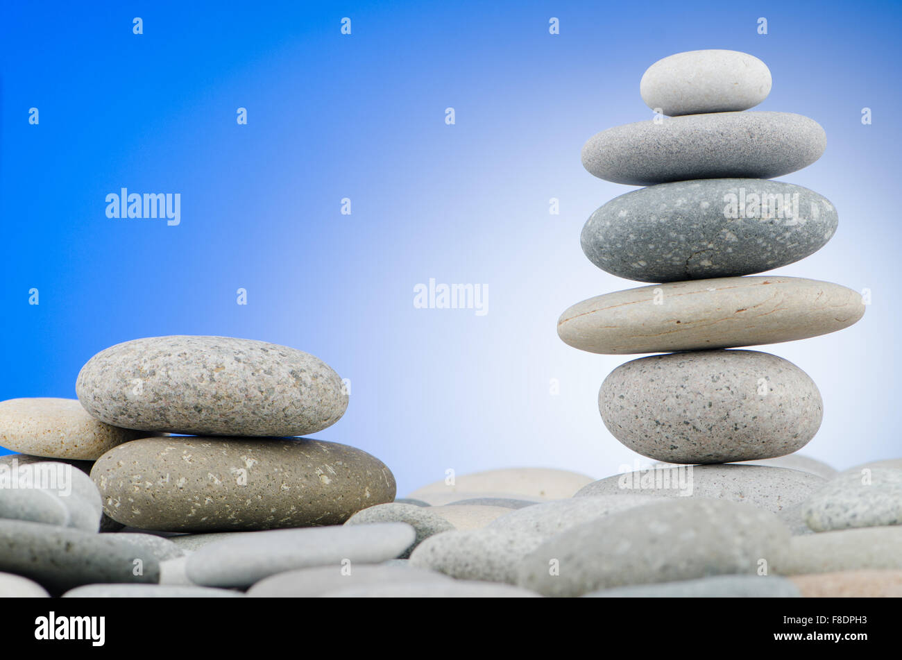 Pebbles stack against gradient background Stock Photo - Alamy