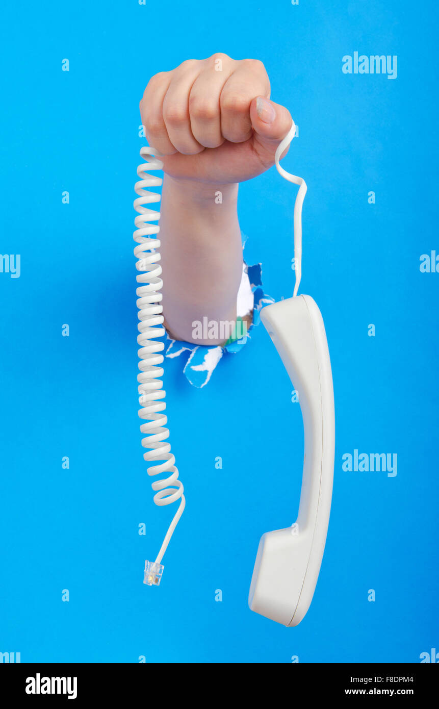 Hand with phone out of paper hole Stock Photo - Alamy