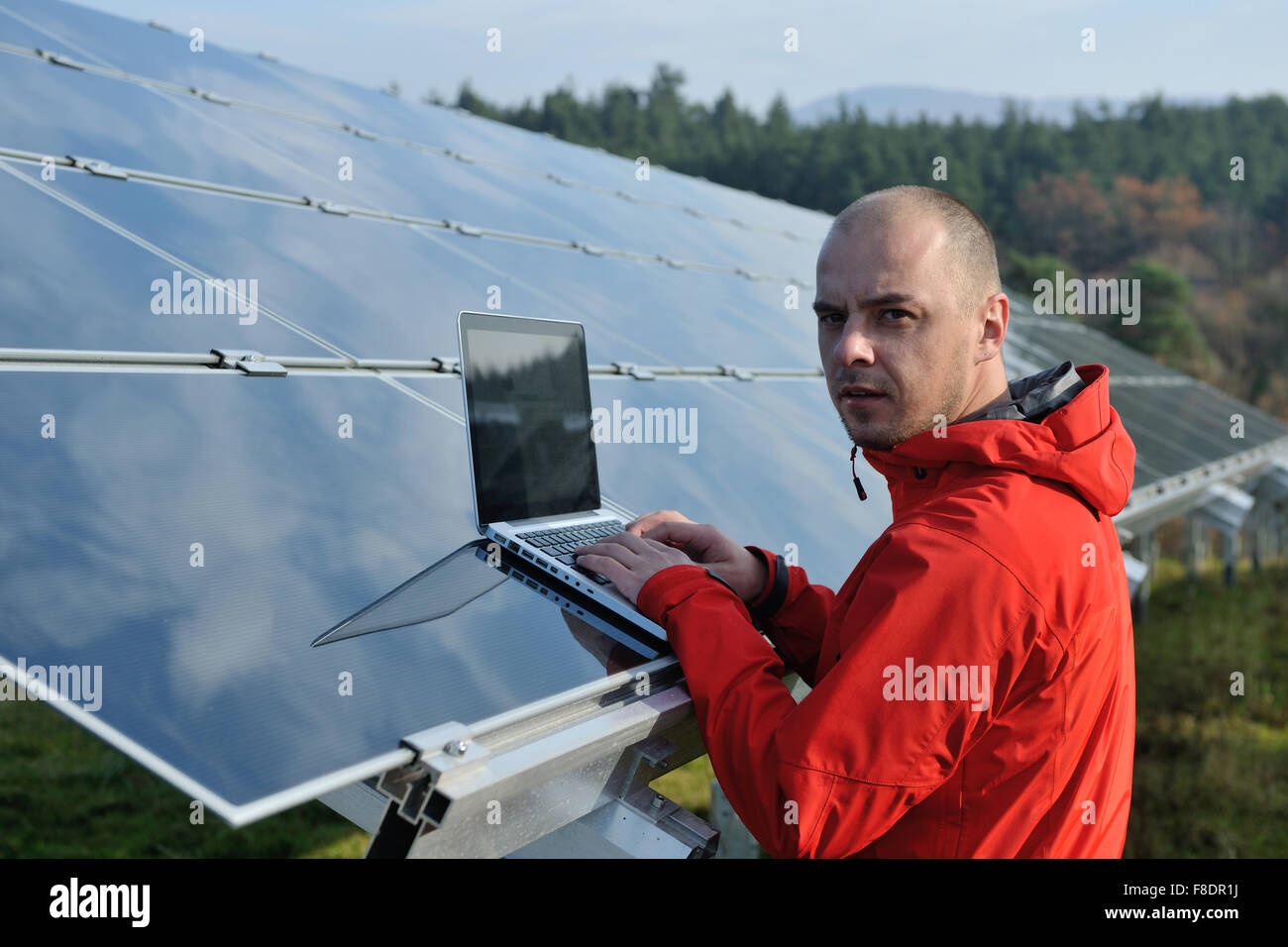 business man engineer using laptop at solar panels plant eco energy ...