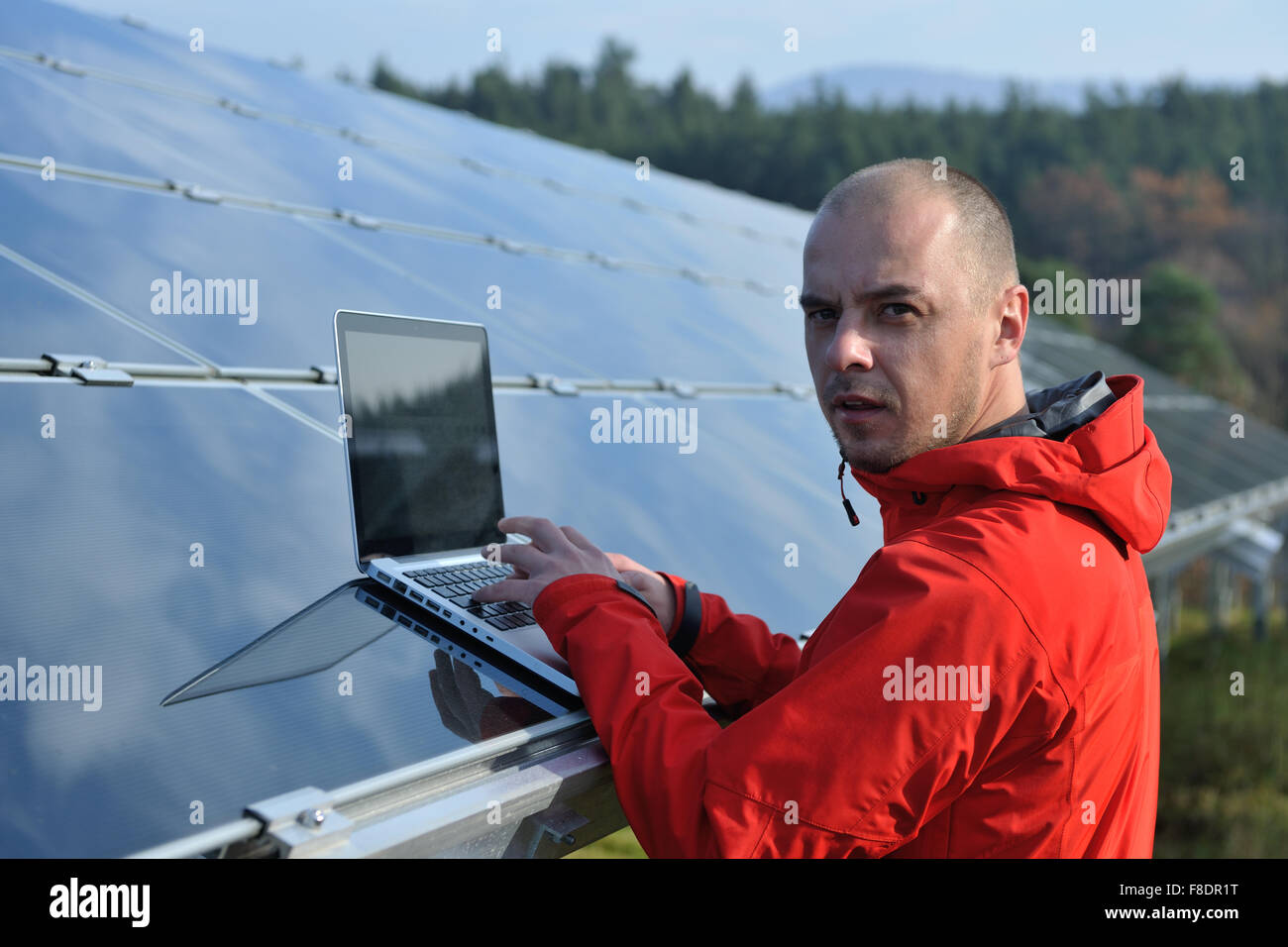 business man engineer using laptop at solar panels plant eco energy ...