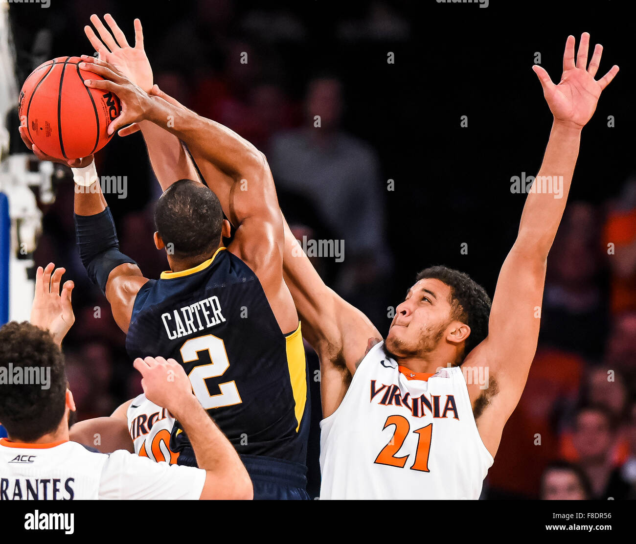 New York, USA. 8th Dec, 2015. Virginia's Isaiah Wilkins tries to block ...