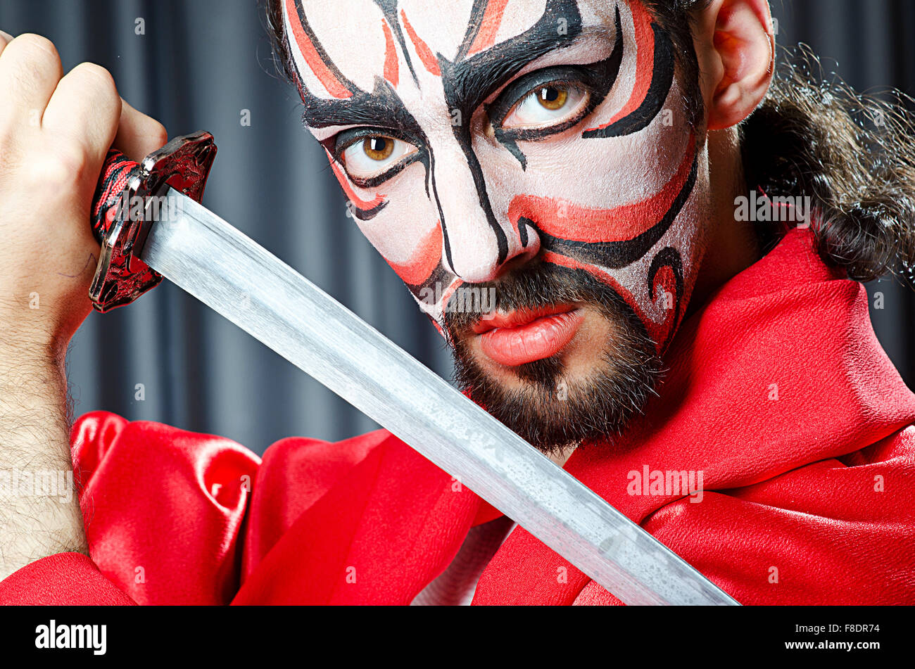 Man with face mask and sword Stock Photo - Alamy