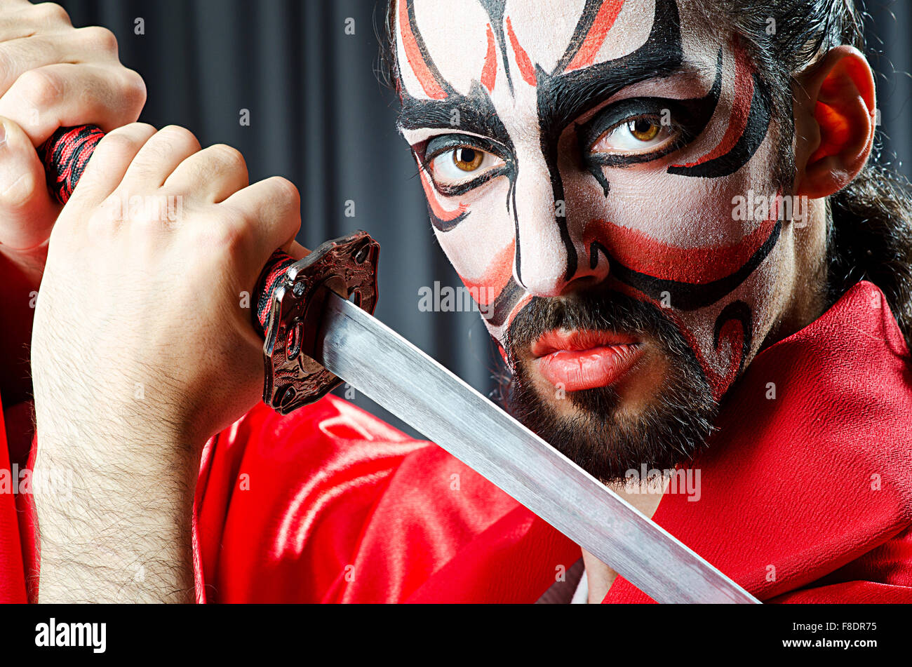Man with face mask and sword Stock Photo - Alamy