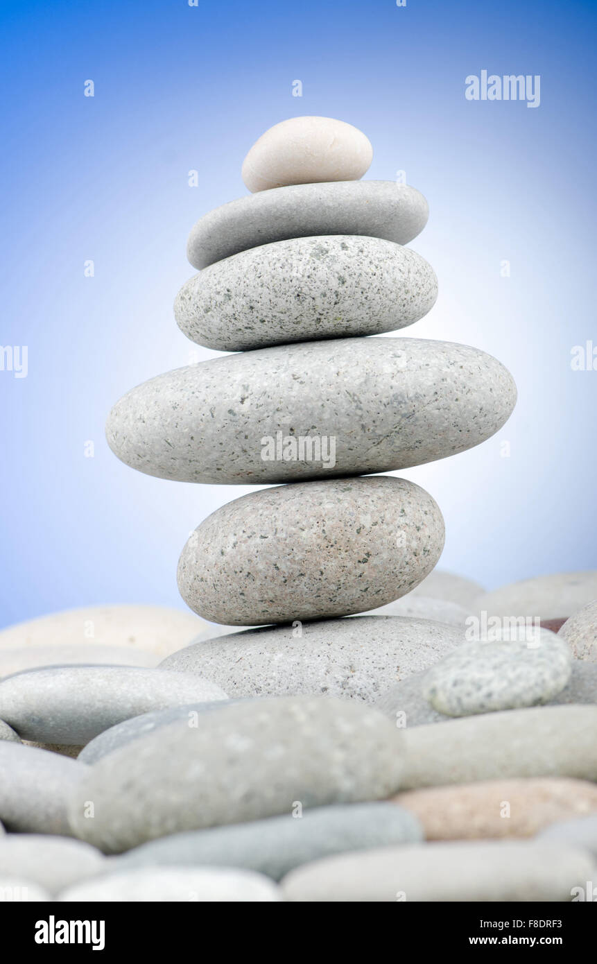 Pebbles stack against gradient background Stock Photo - Alamy