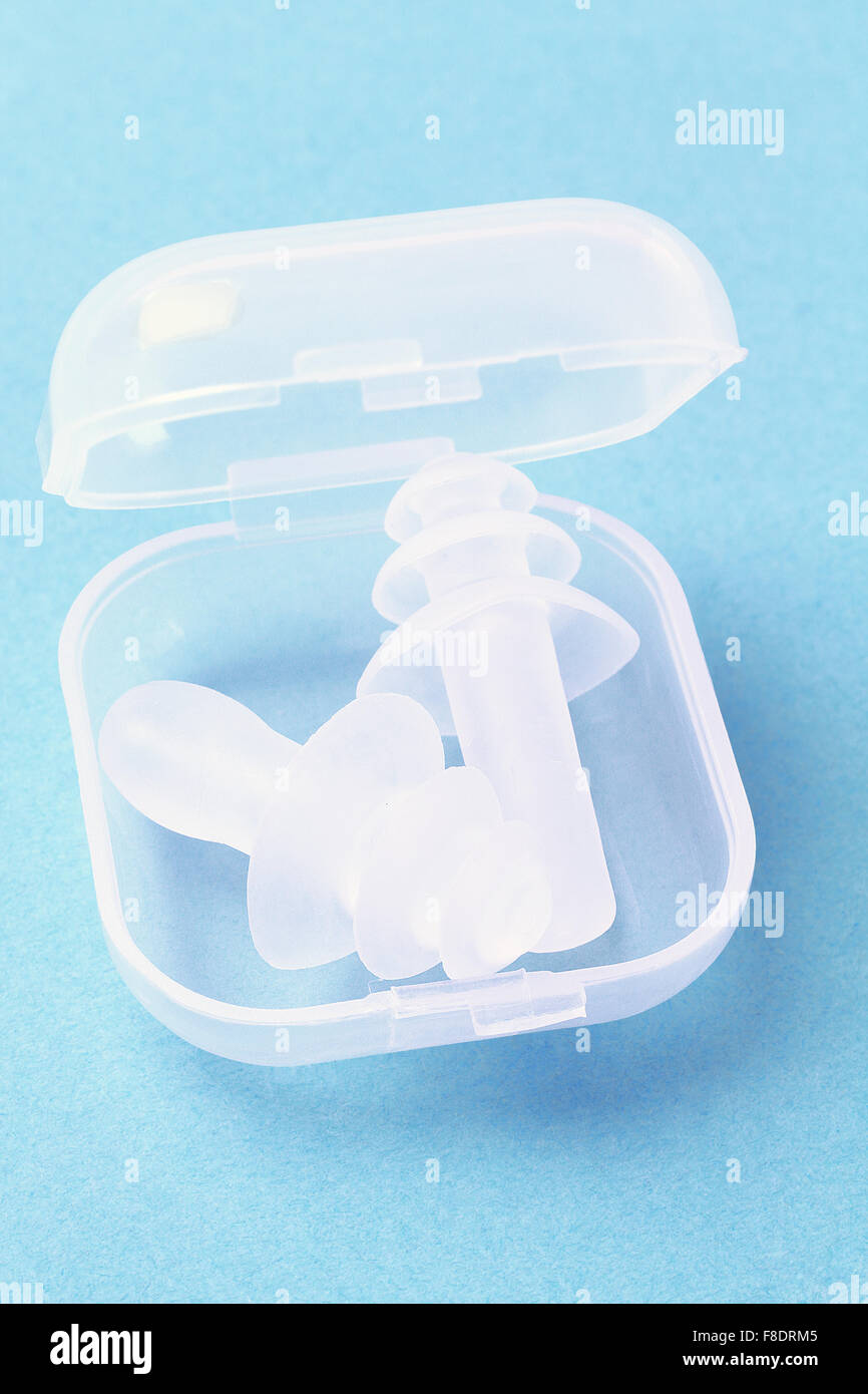Pair of Ear Plugs in Open Plastic Container on Blue Background Stock ...