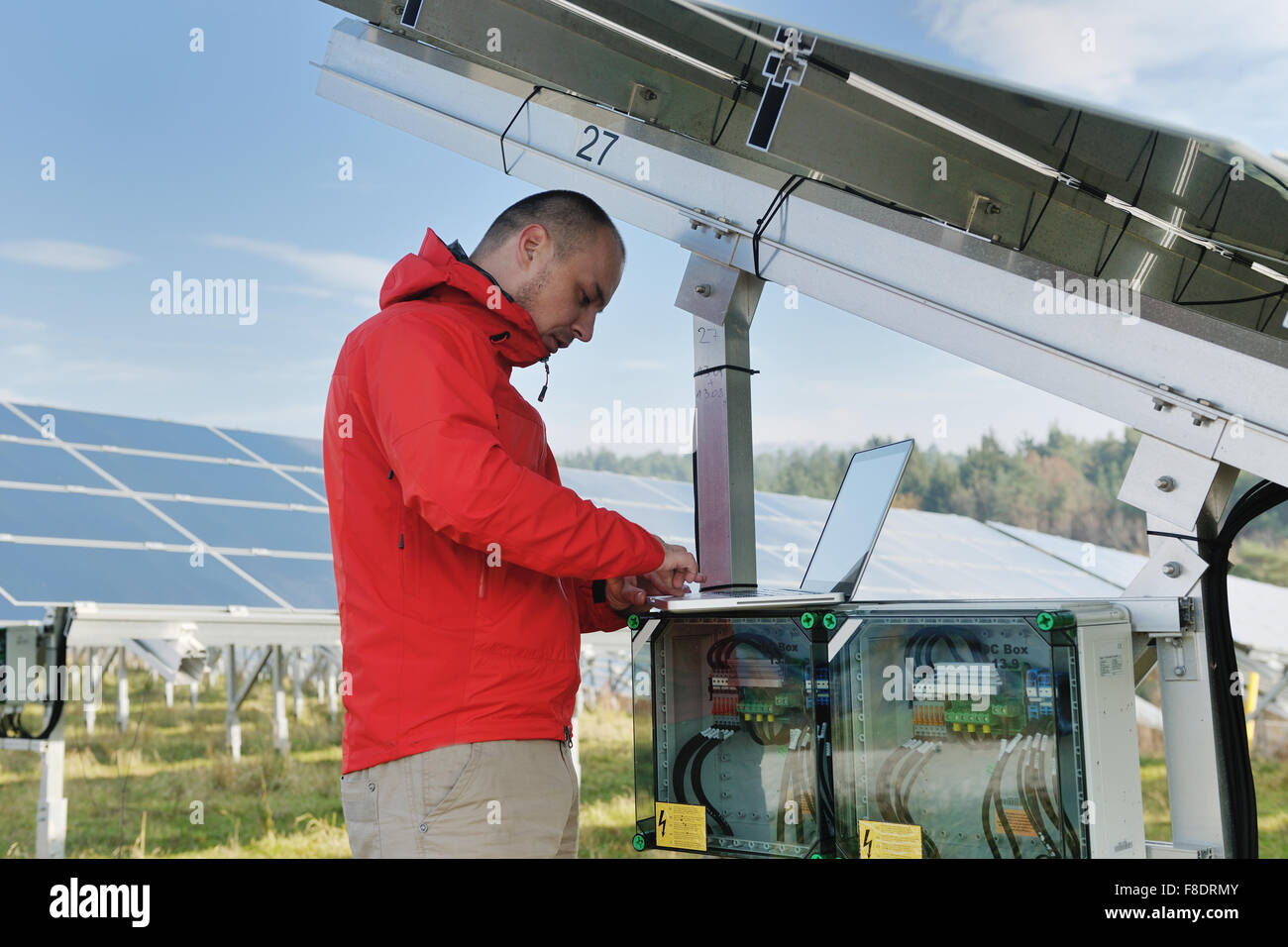 business man engineer using laptop at solar panels plant eco energy ...