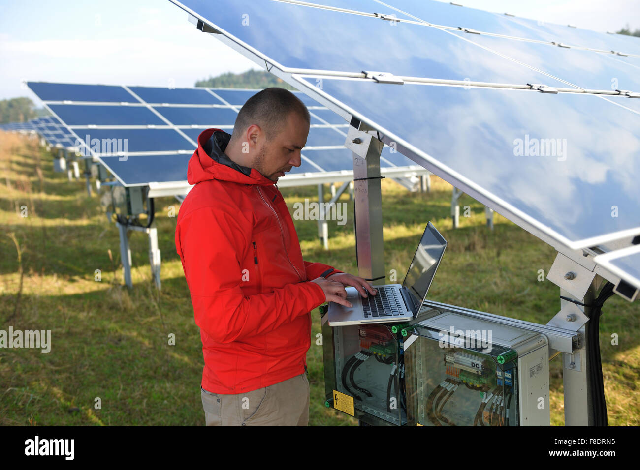 business man engineer using laptop at solar panels plant eco energy ...