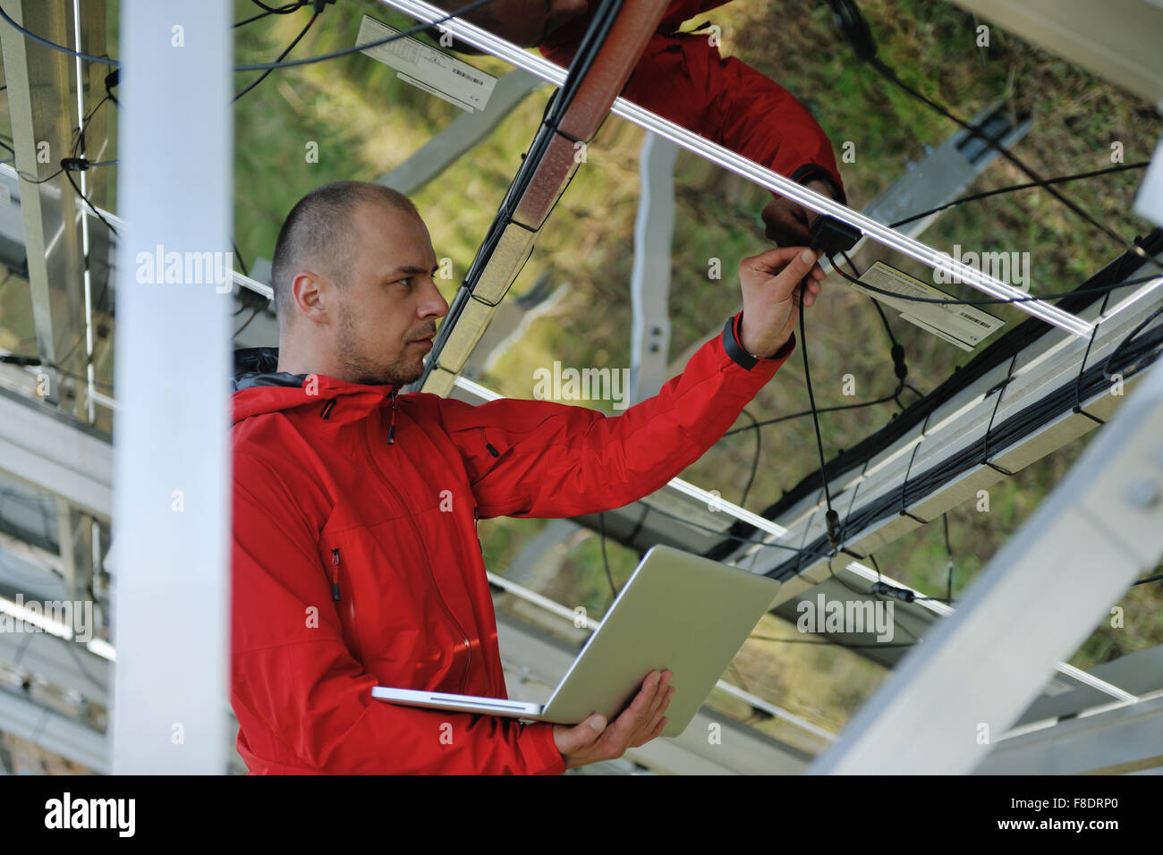 business man engineer using laptop at solar panels plant eco energy ...