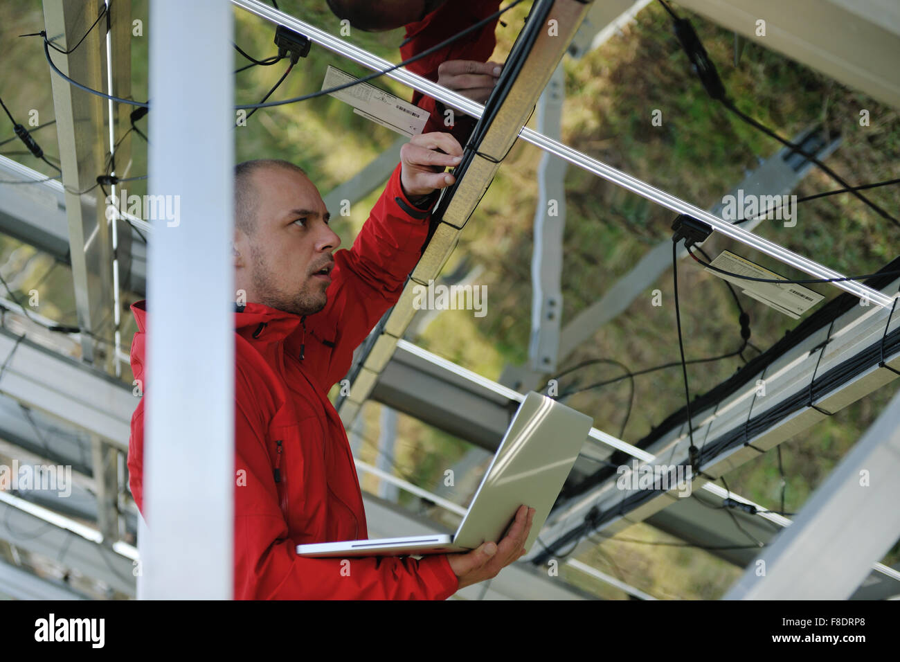 business man engineer using laptop at solar panels plant eco energy ...