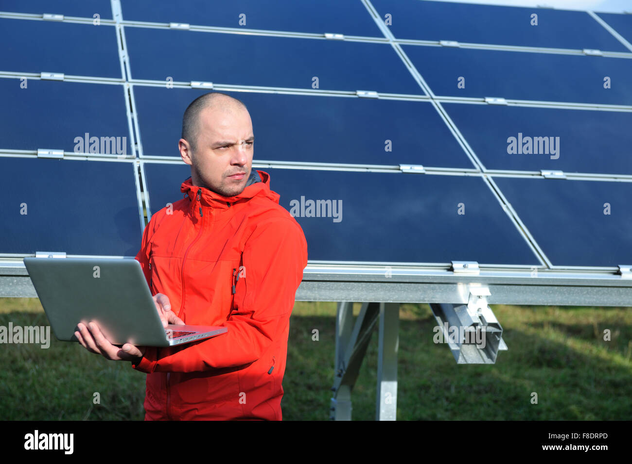 business man engineer using laptop at solar panels plant eco energy ...